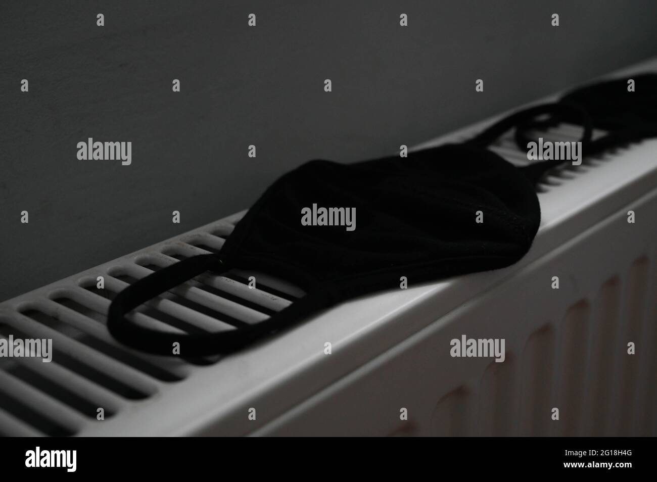 Reusable face masks dry at home on the radiator Stock Photo - Alamy