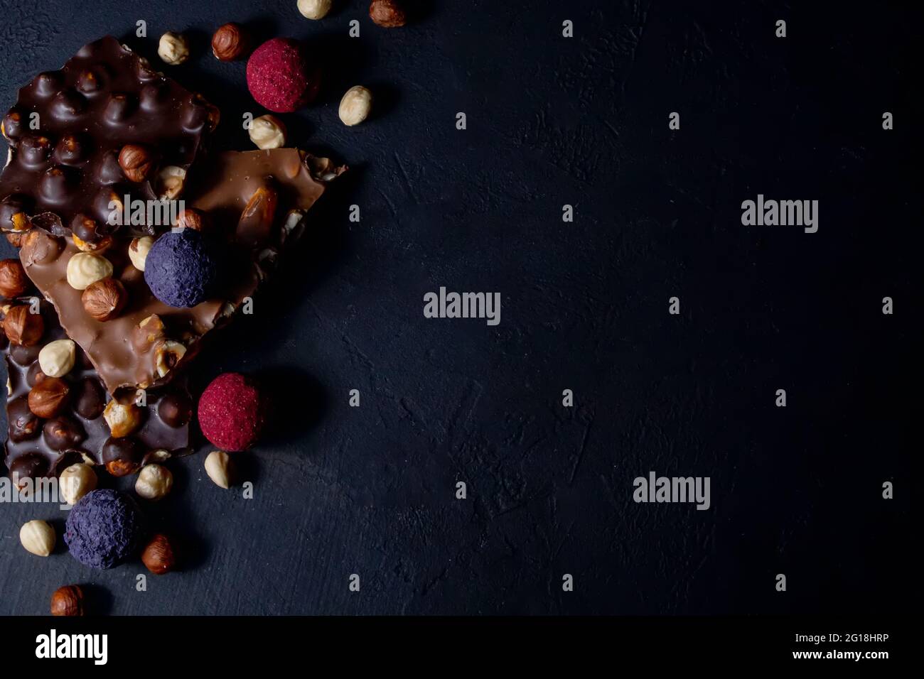 Chocolate bar, crushed pieces of dark chocolate and nuts. Praline ...