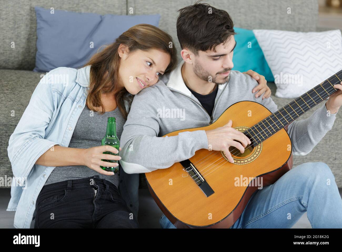 romantic couple having fun at home playing guitar Stock Photo - Alamy