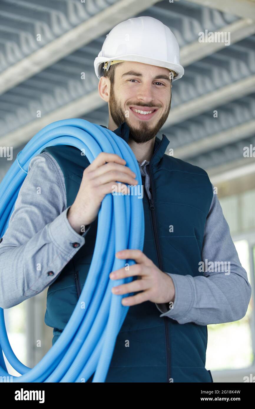 builder holding water pipes Stock Photo - Alamy