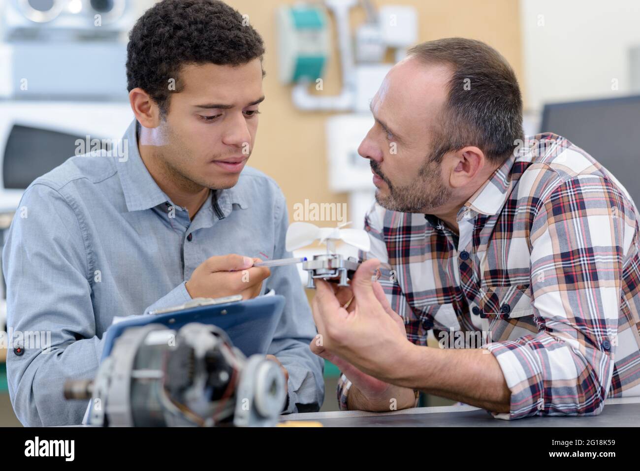 Two men repairing electronic hi-res stock photography and images - Alamy