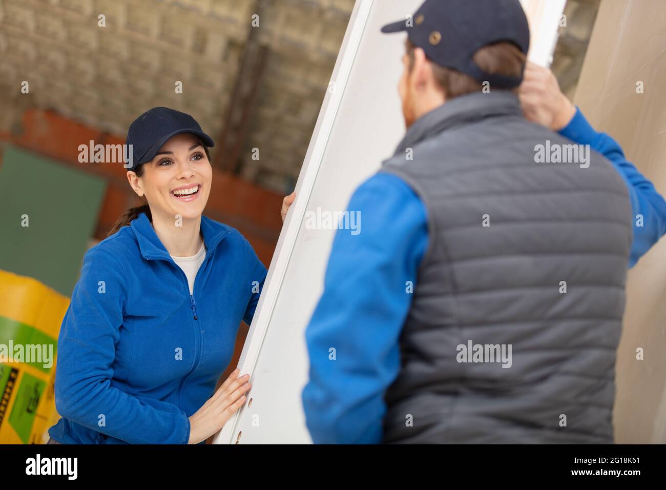 two cheerful builders working together Stock Photo - Alamy