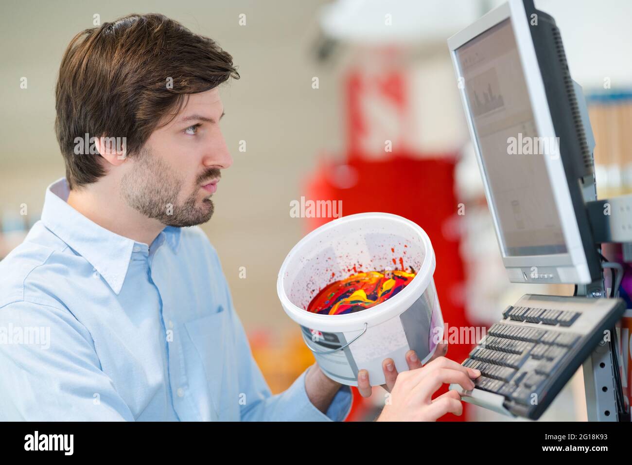 portrait of hardware store worker checking paint in computer Stock ...
