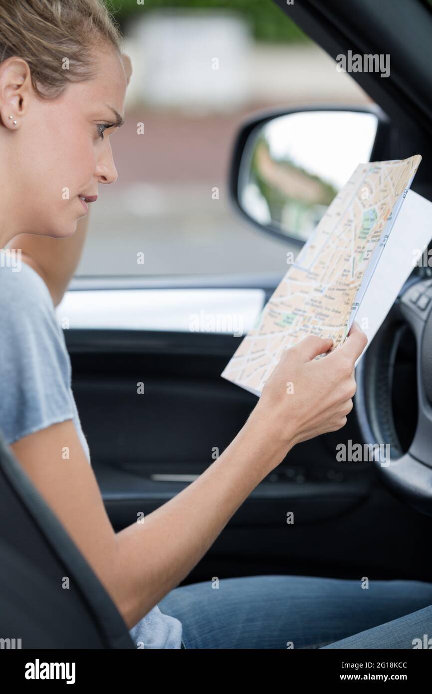 confused woman with a map on the road Stock Photo - Alamy
