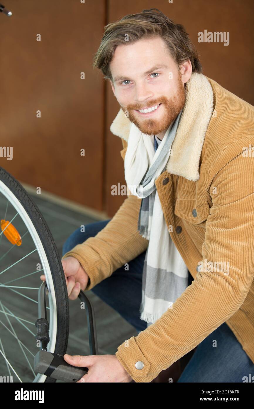 Man fixing bicycle home male hi-res stock photography and images - Alamy