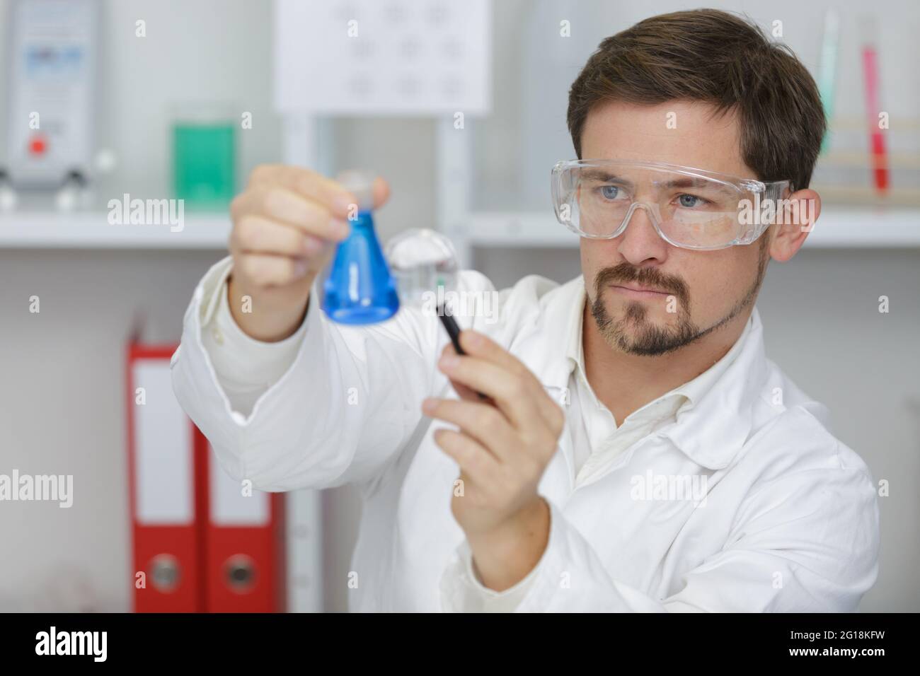 male scientist researcher conducting an experiment in lab Stock Photo ...