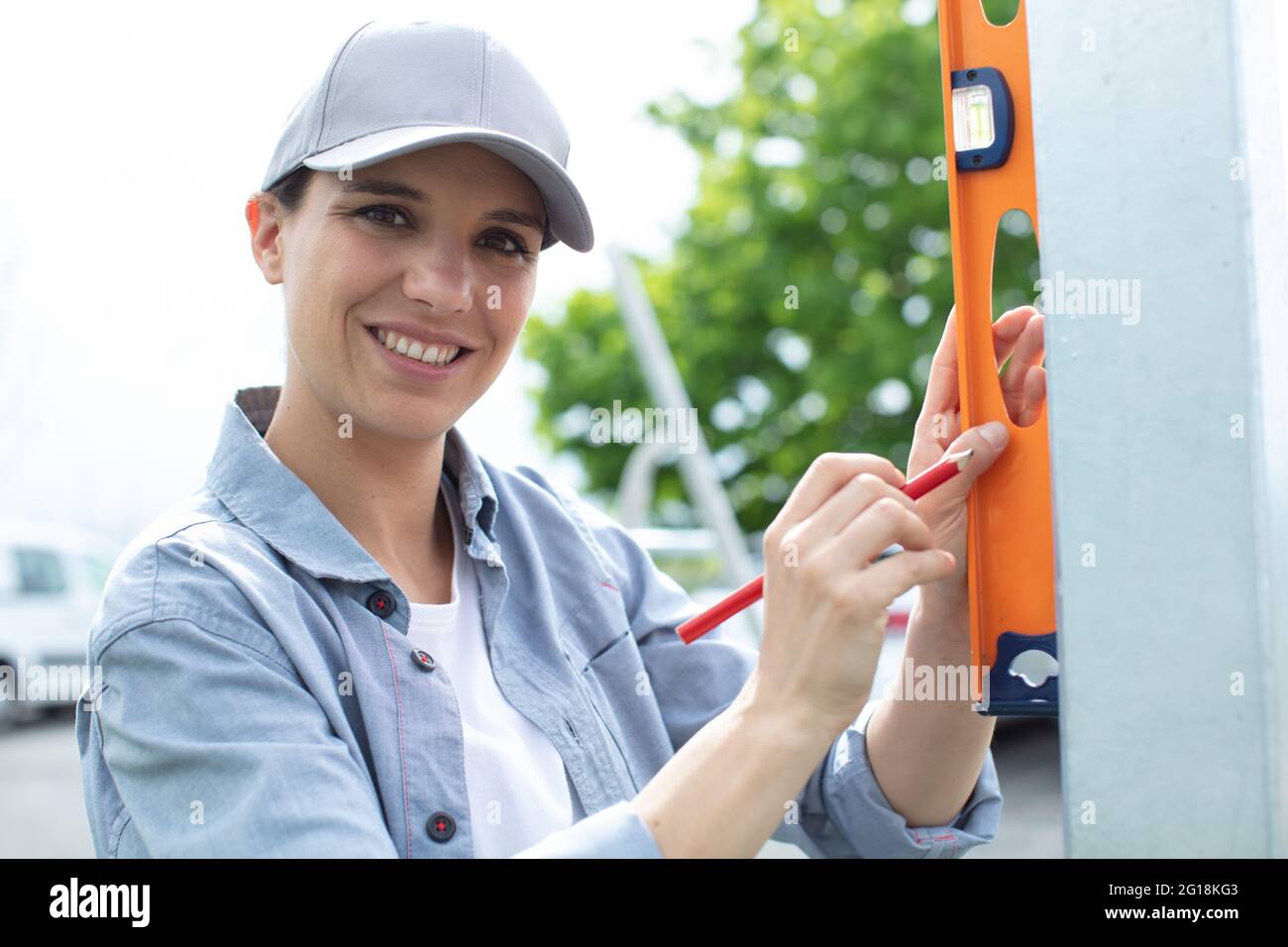 female worker using level at site Stock Photo - Alamy
