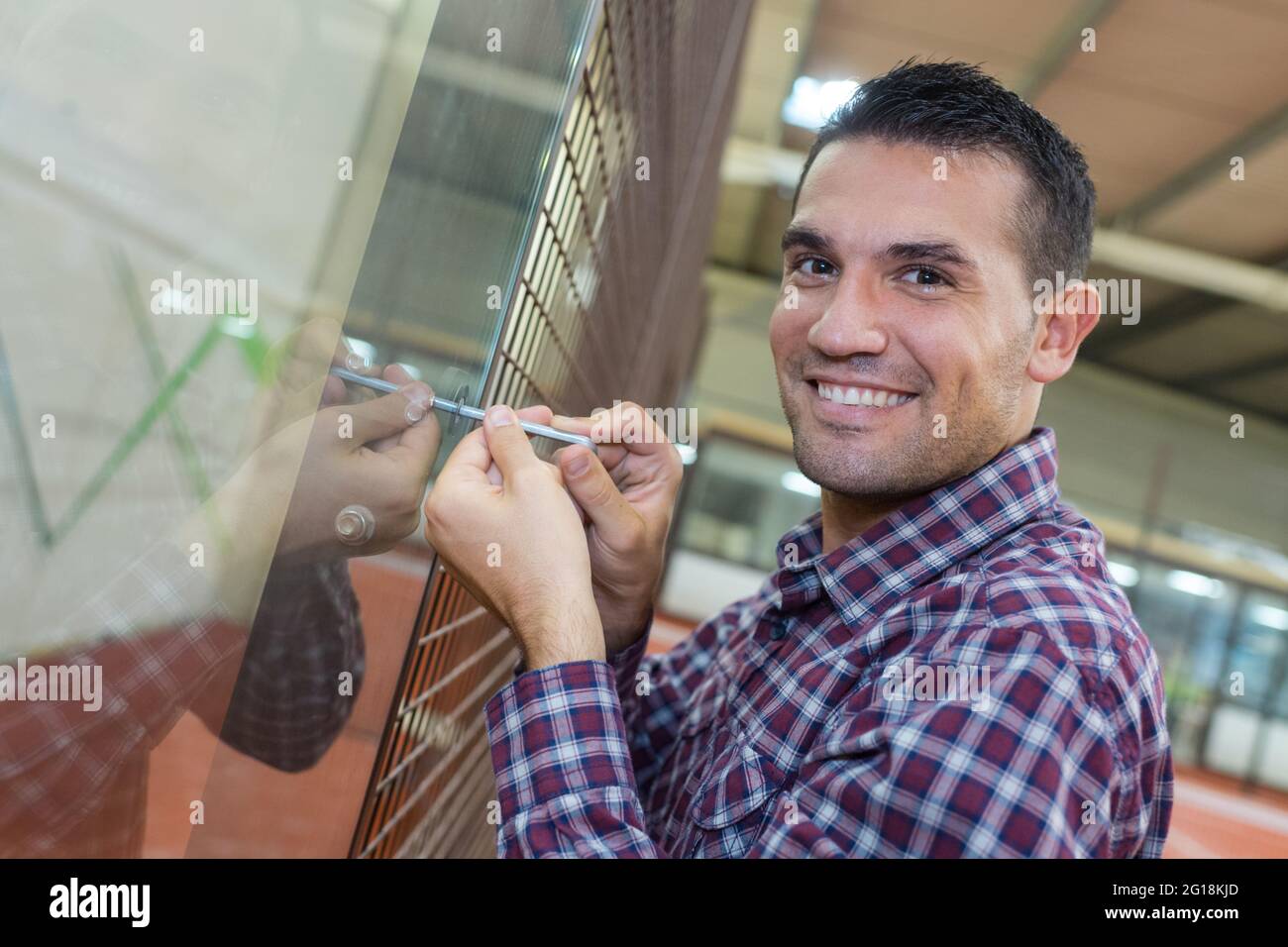 happy electrician mounting electrical wall with screw driver Stock ...