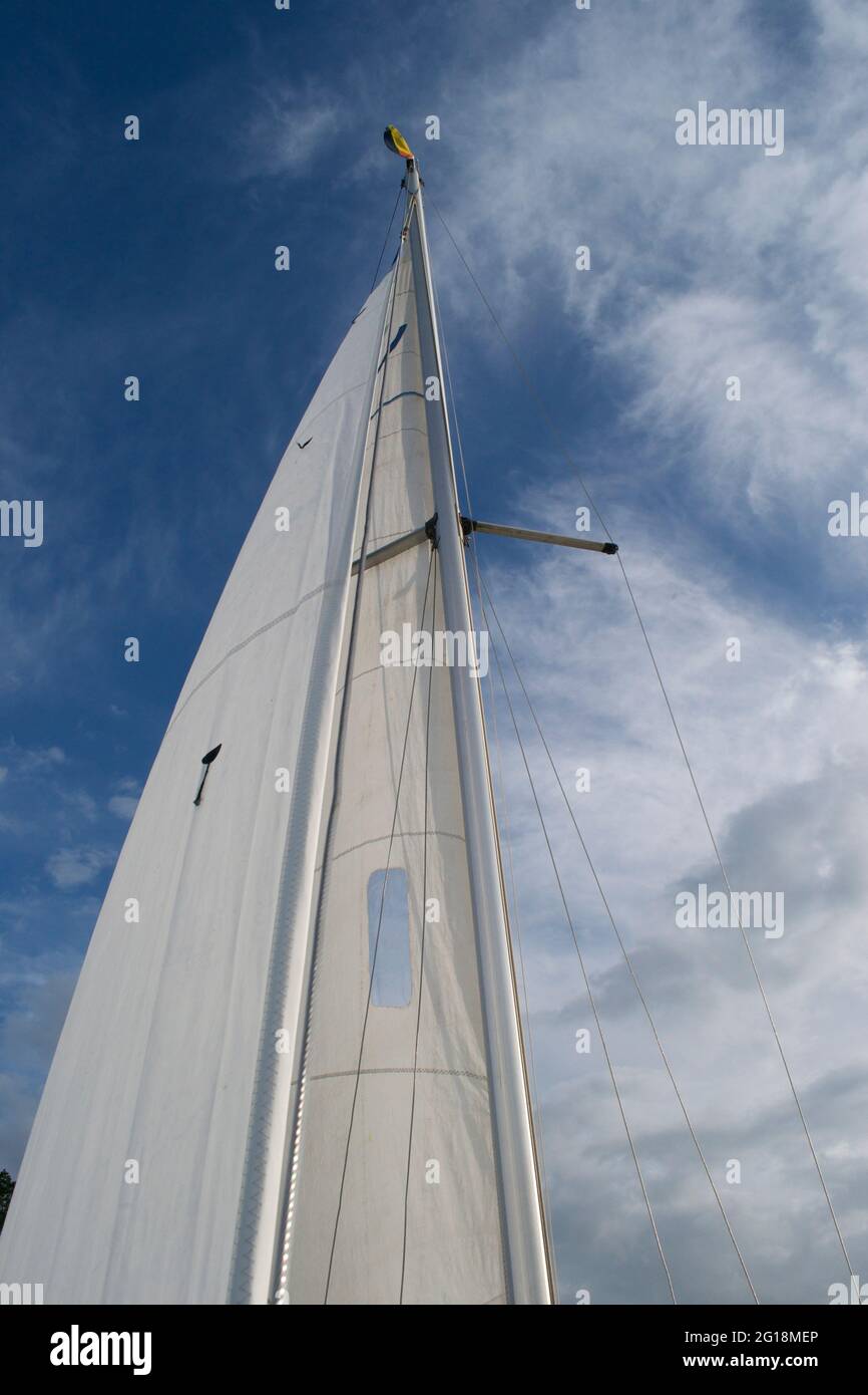 Looking up the metal mast of a sailing boat under sail. A bermuda ...
