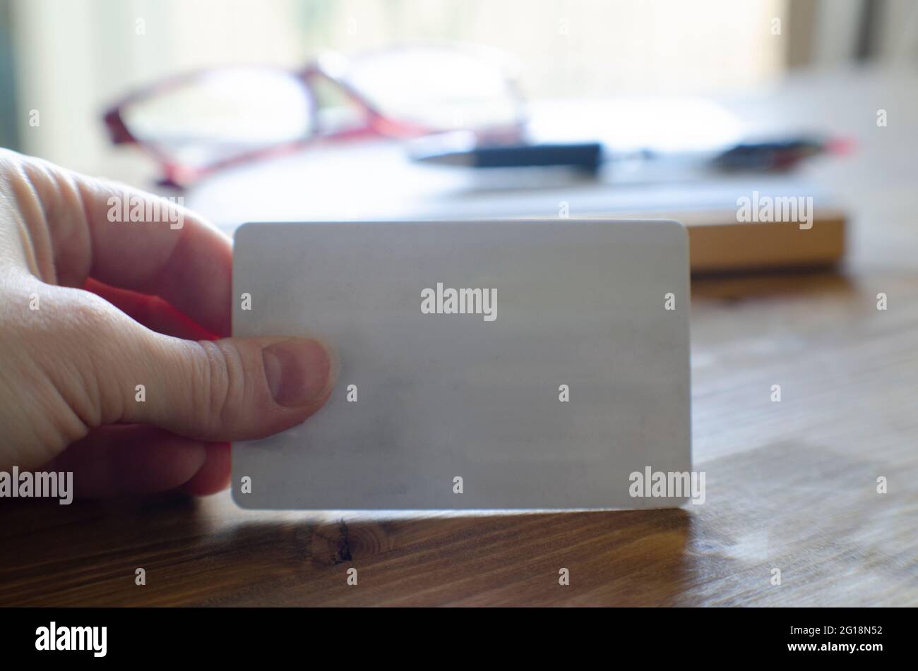 Hand holding insurance card Stock Photo - Alamy