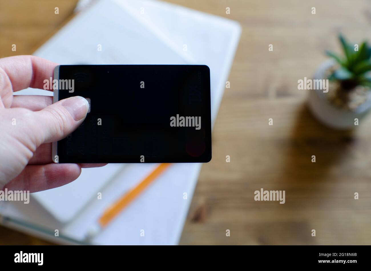 Female hand holding blank black credit card template over blank ...