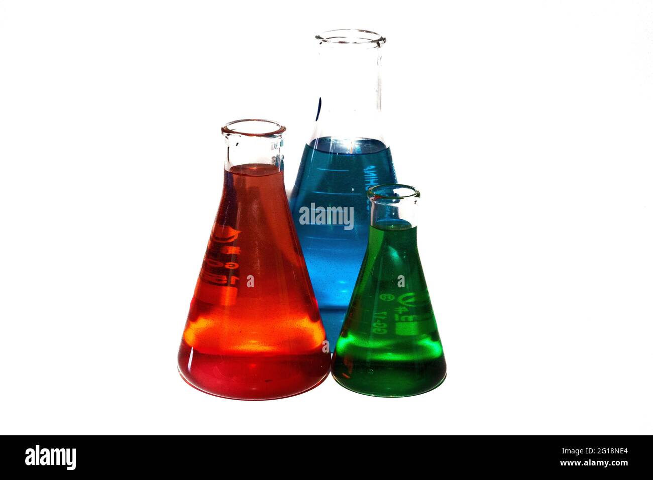 A color liquid in multiple glass beakers on a white background ...