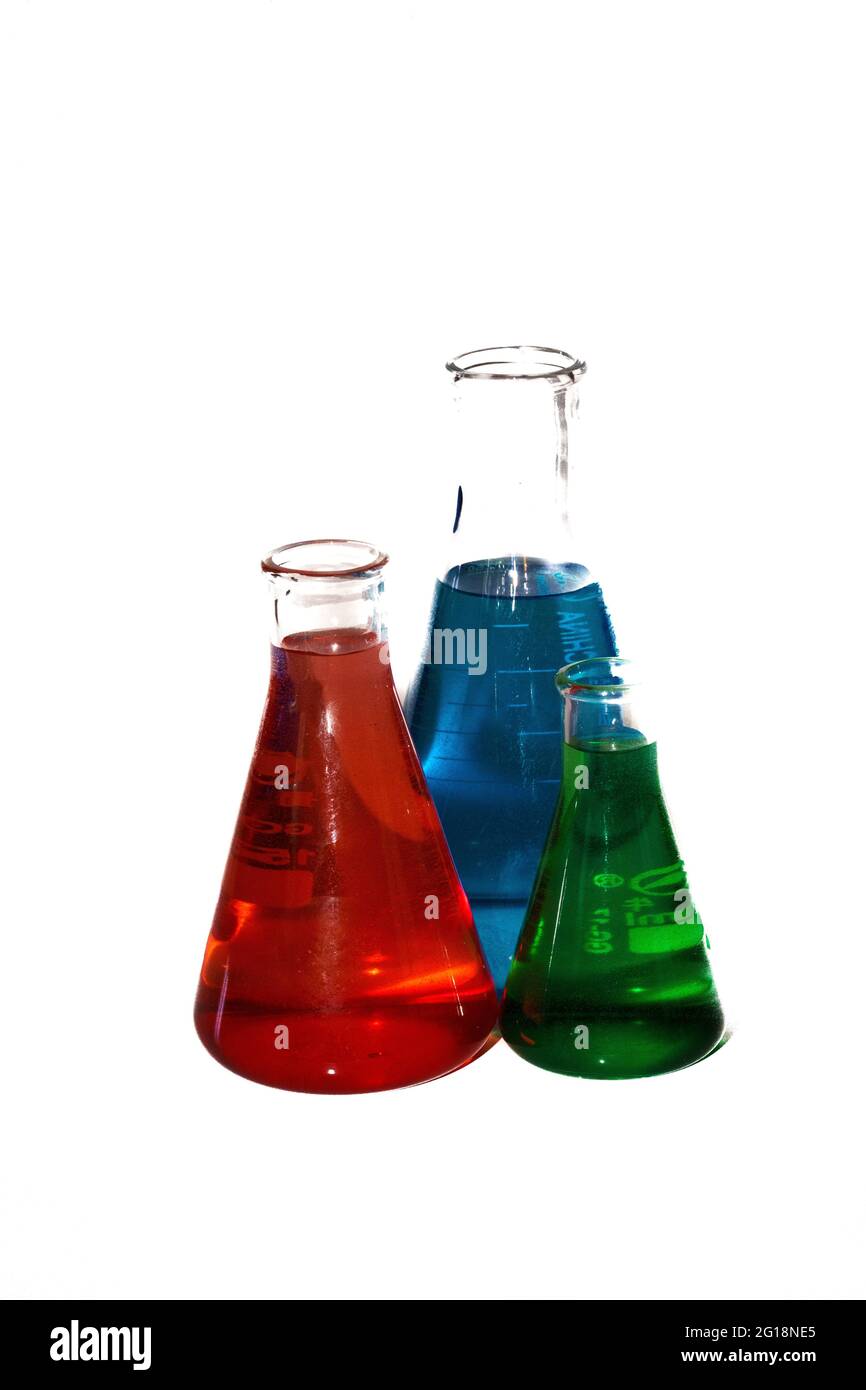 A color liquid in multiple glass beakers on a white background ...