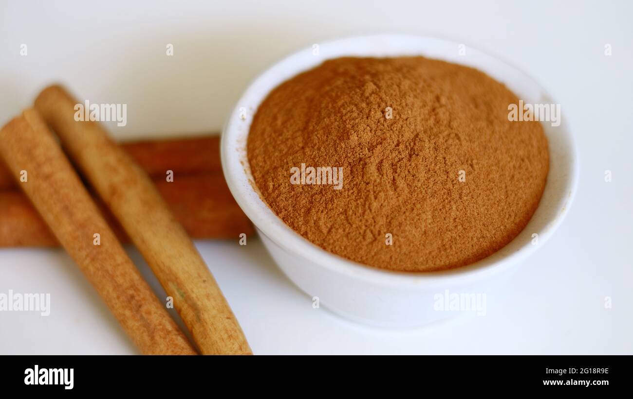 Cinnamon and cinnamon powder on white background Stock Photo - Alamy