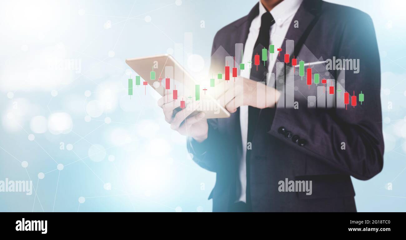 Businessman hold tablet and graph stock and funds to financial while ...
