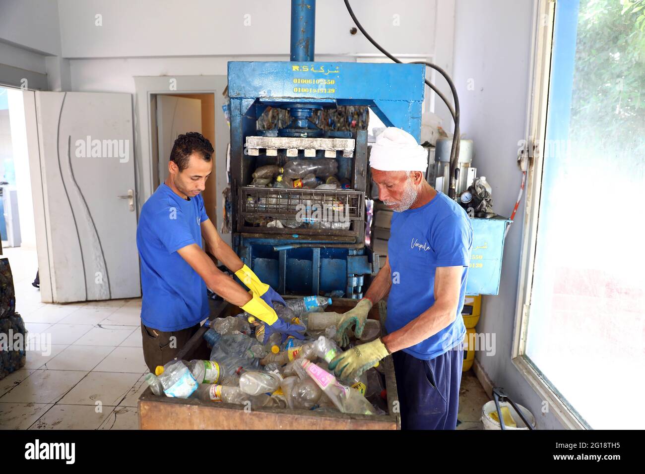 Giza, Egypt. 5th June, 2021. People handle plastic bottles collected ...