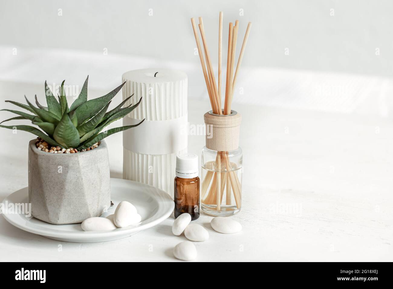 Close-up of an aroma stick for a room smell and a jar of aromatic oil ...
