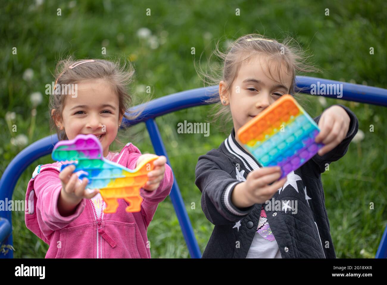Little girls playing a new fidget toy popular with children helps them ...
