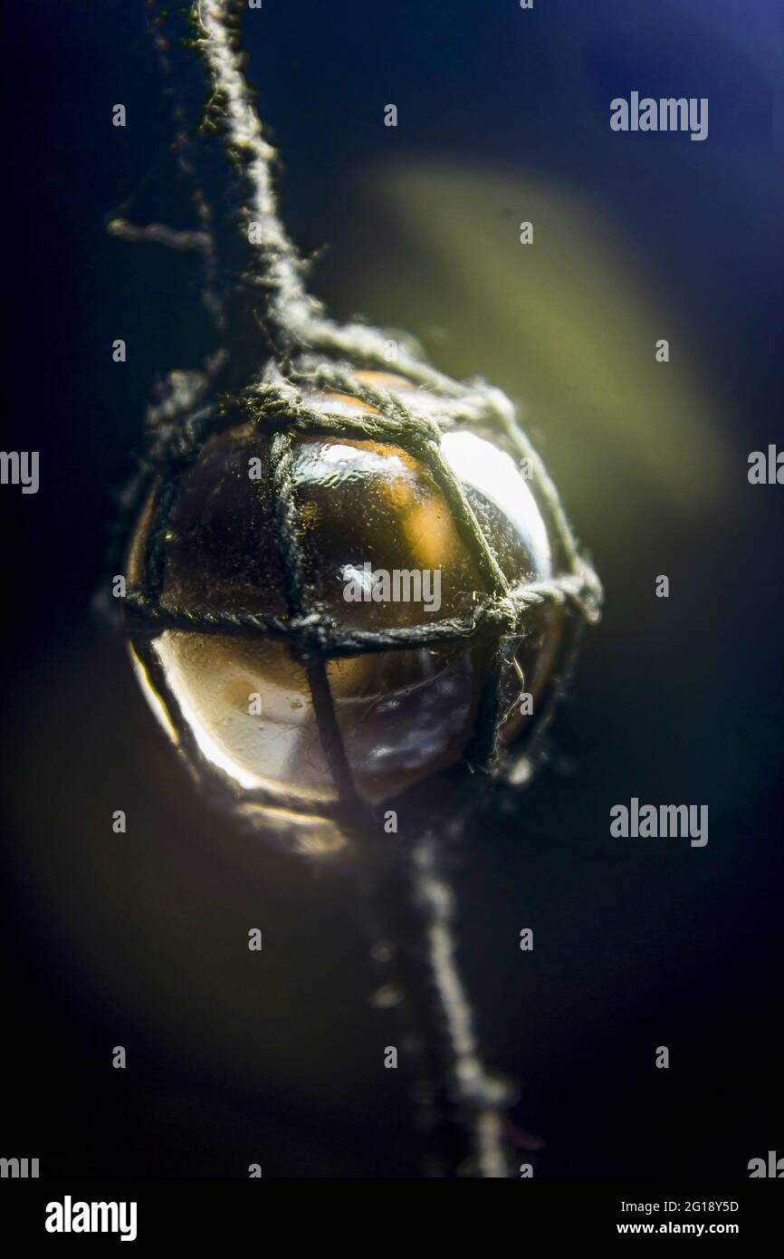 A glass fishing float with rope Stock Photo - Alamy