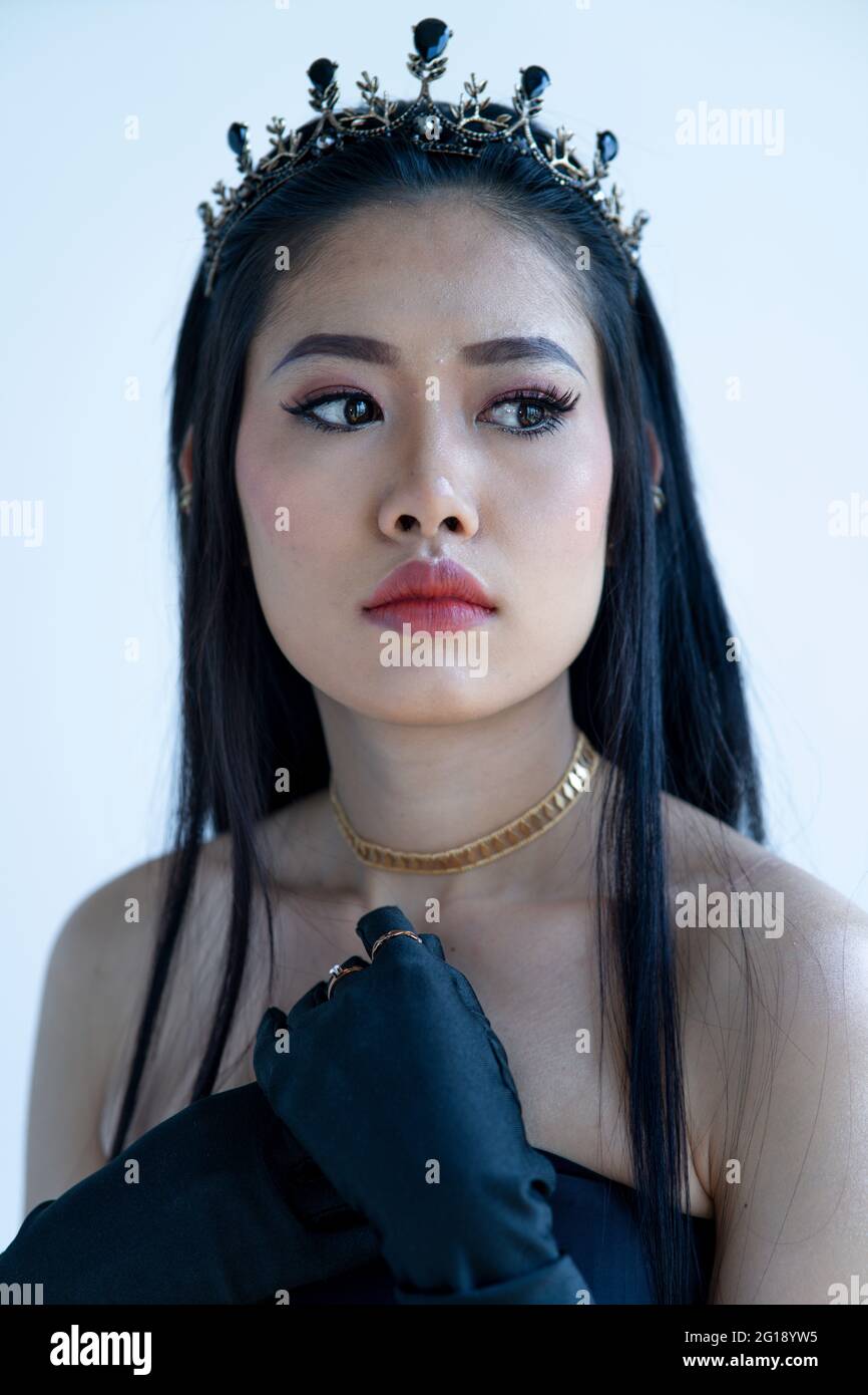 Dark hair asian girl wearing crown Stock Photo - Alamy