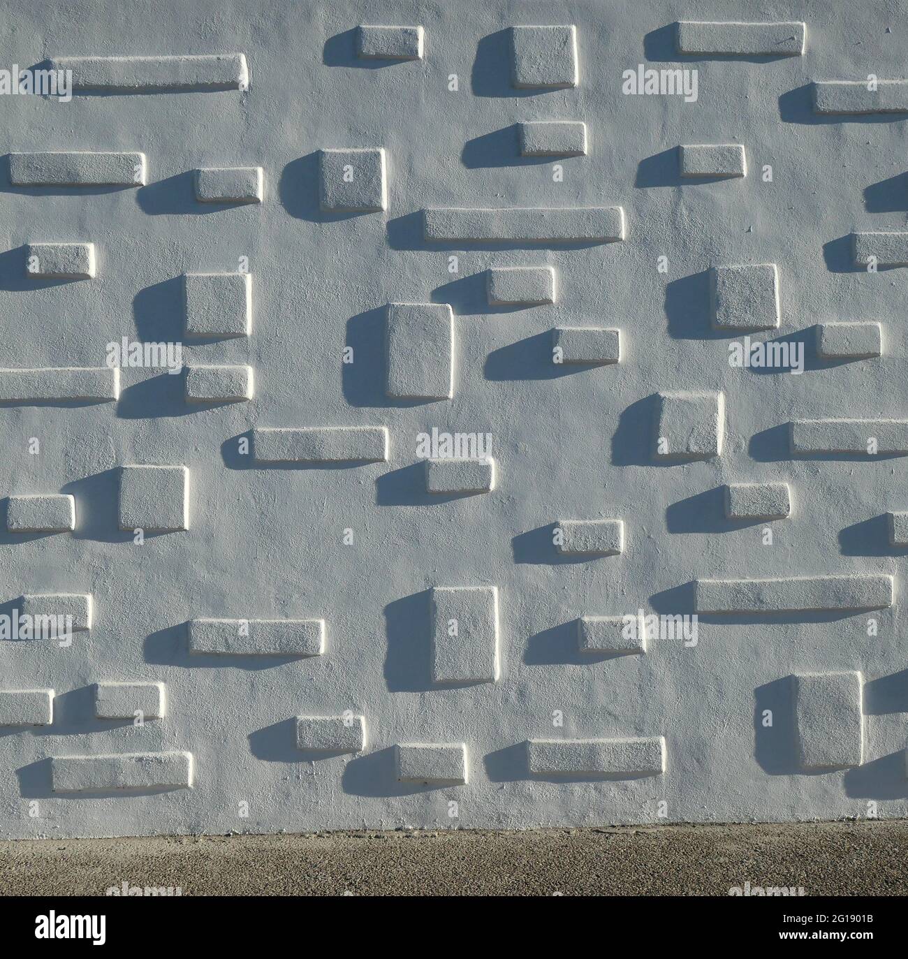 Brick wall with protruding squares and rectangles on village public ...