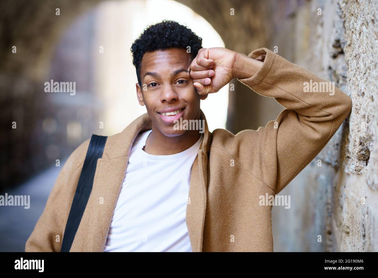 Young black man looking at camera outdoors Stock Photo - Alamy