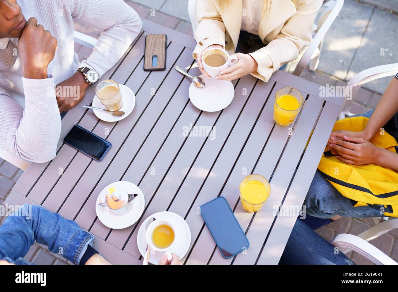 Top view of people drinking some beverages sitting at the table on the ...