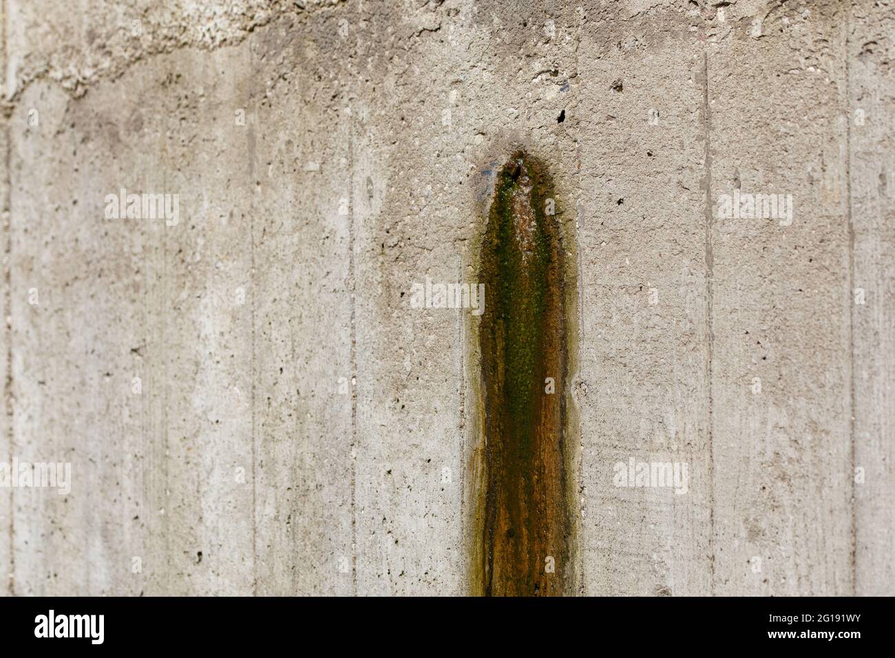 Weeping hole with slurry stain on a concrete retention wall. Close-up ...