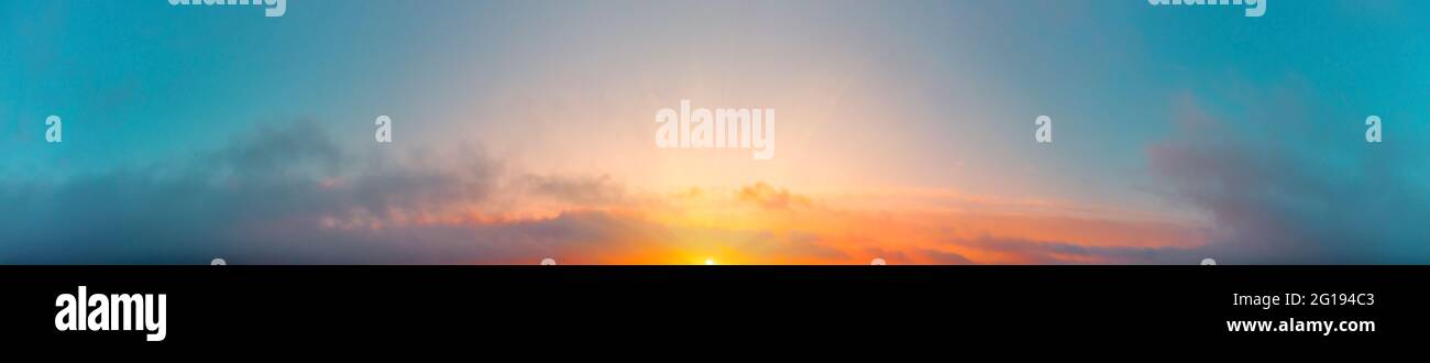 Panorama of colorful sunrise with the rising sun Stock Photo - Alamy