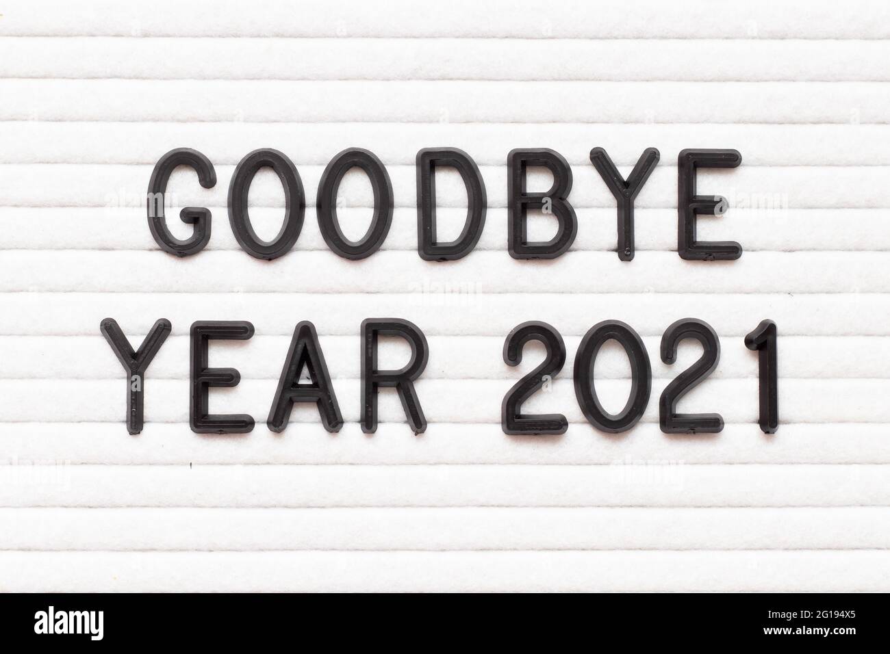 Black color letter in word goodbye year 2021 on white felt board ...