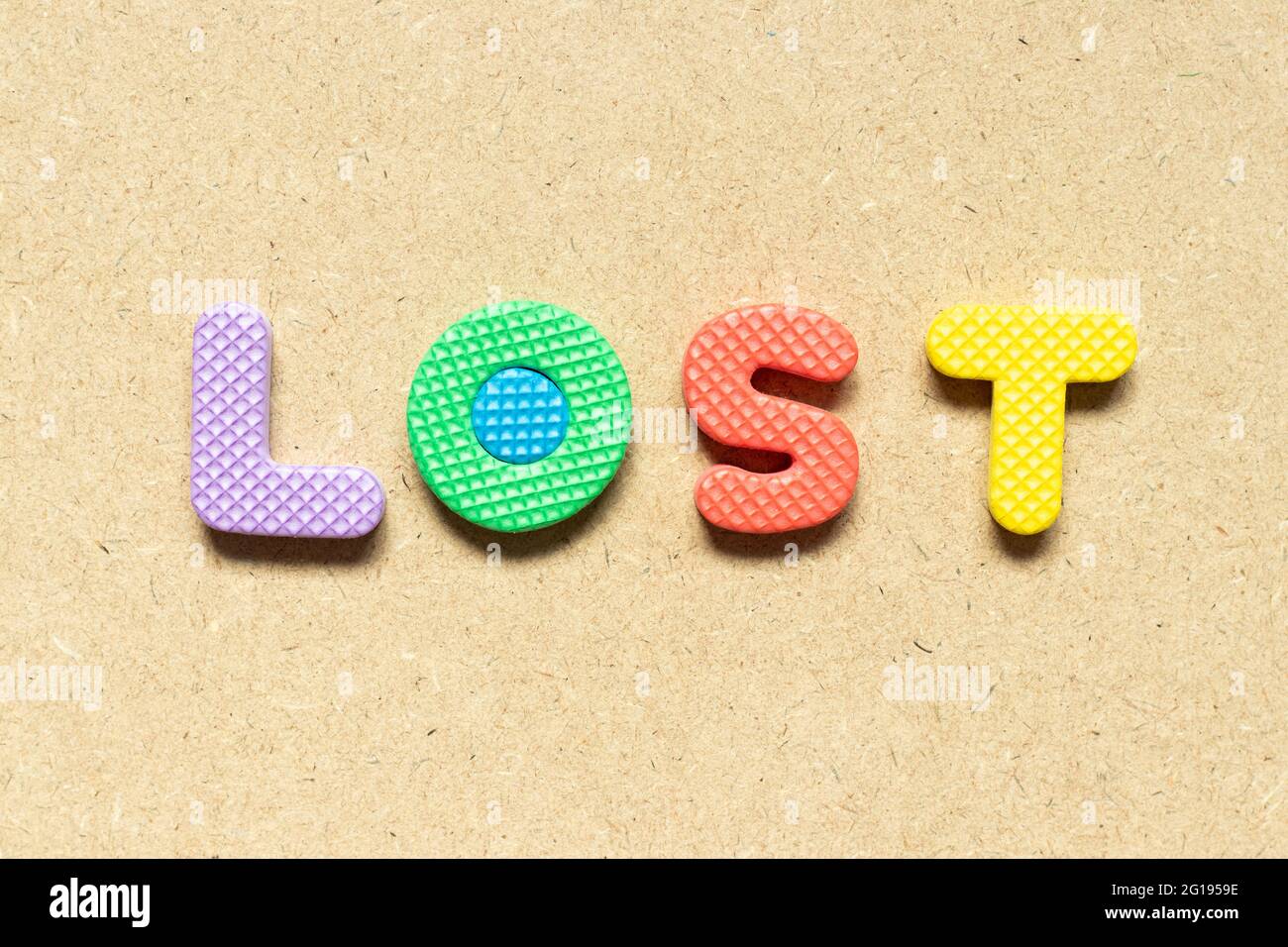 Foam alphabet letter in word lost on wood background Stock Photo - Alamy