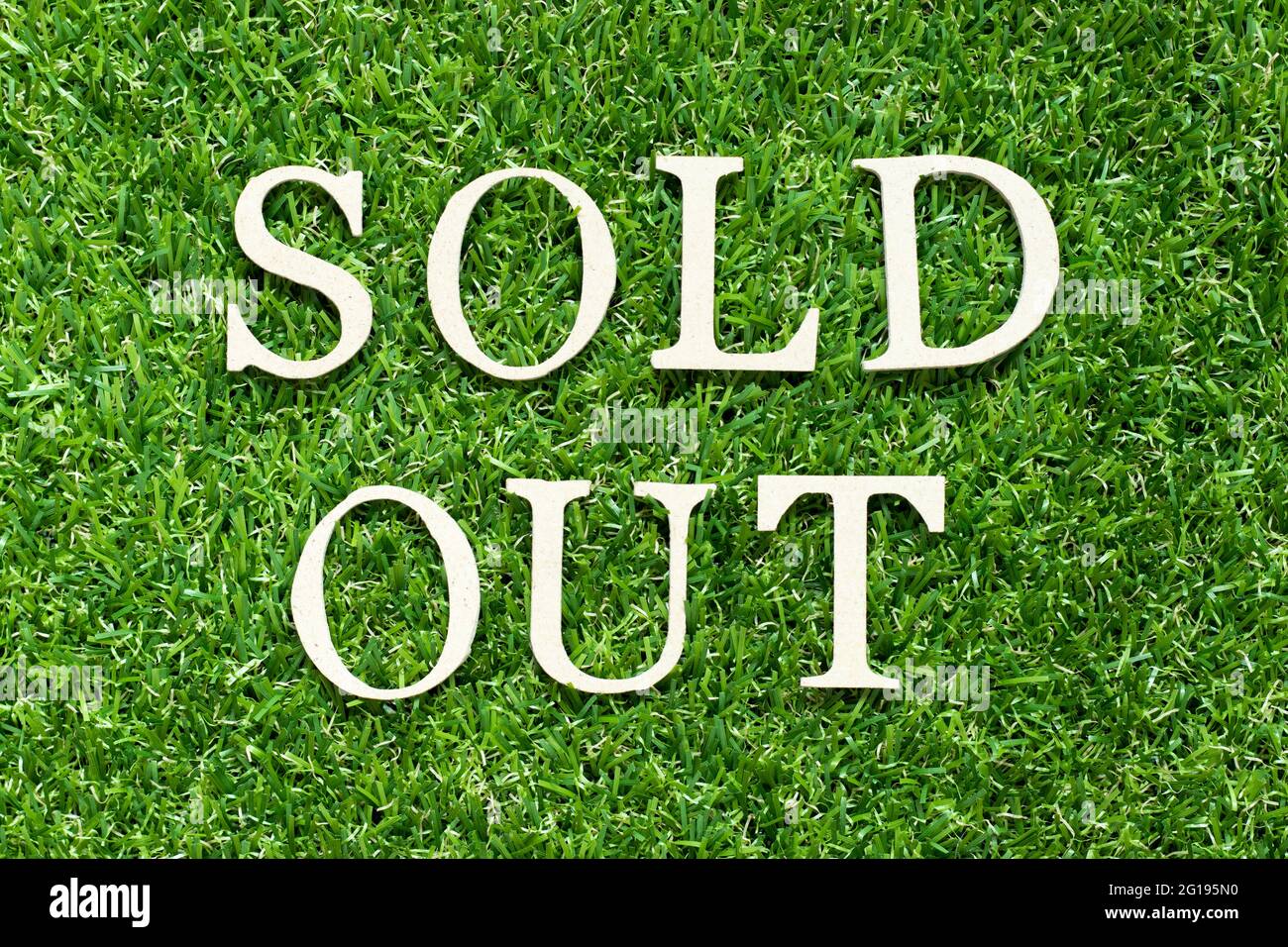 Alphabet letter in word sold out on green grass background Stock Photo ...
