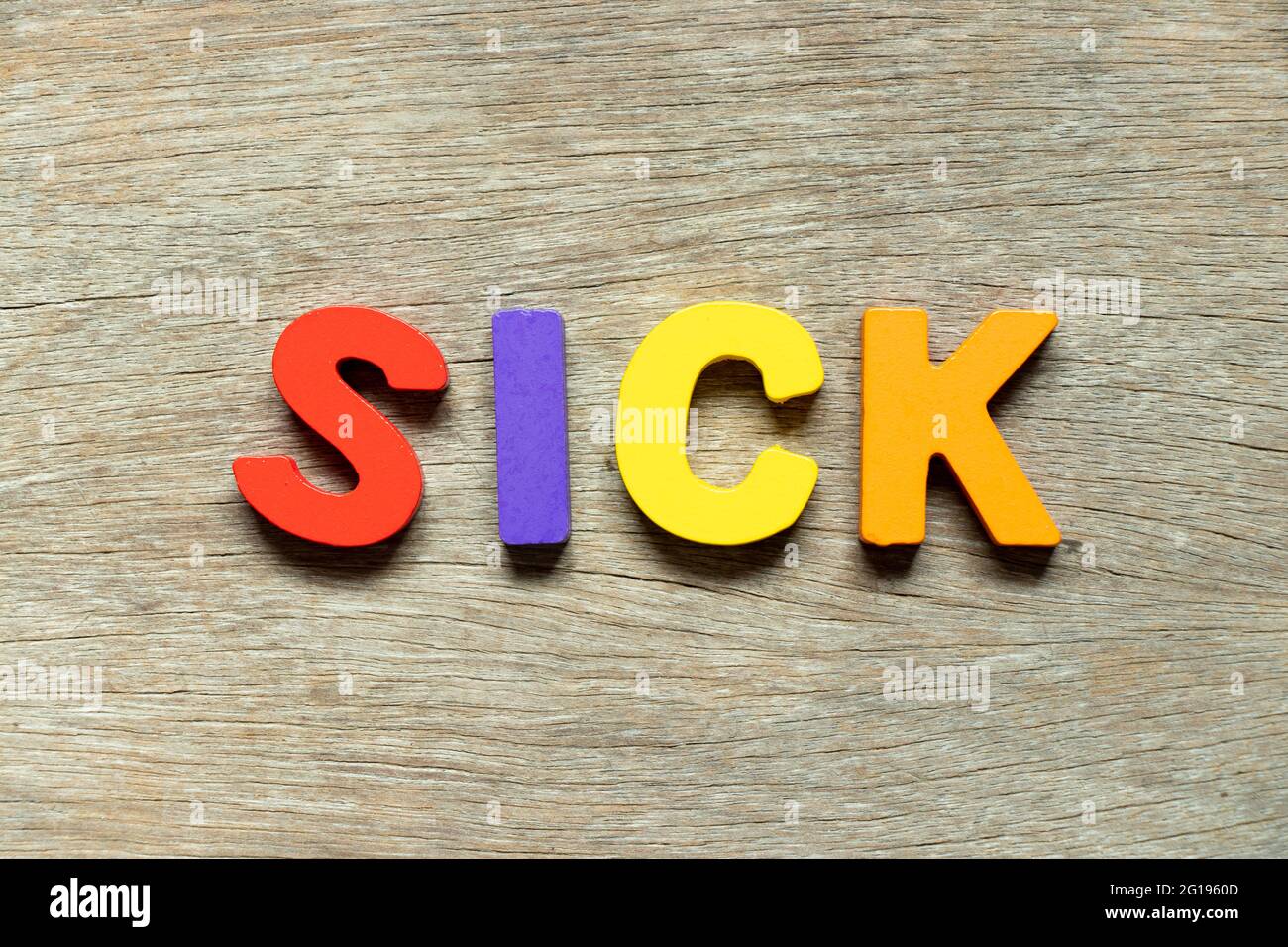 Color alphabet letter in word sick on wood background Stock Photo - Alamy
