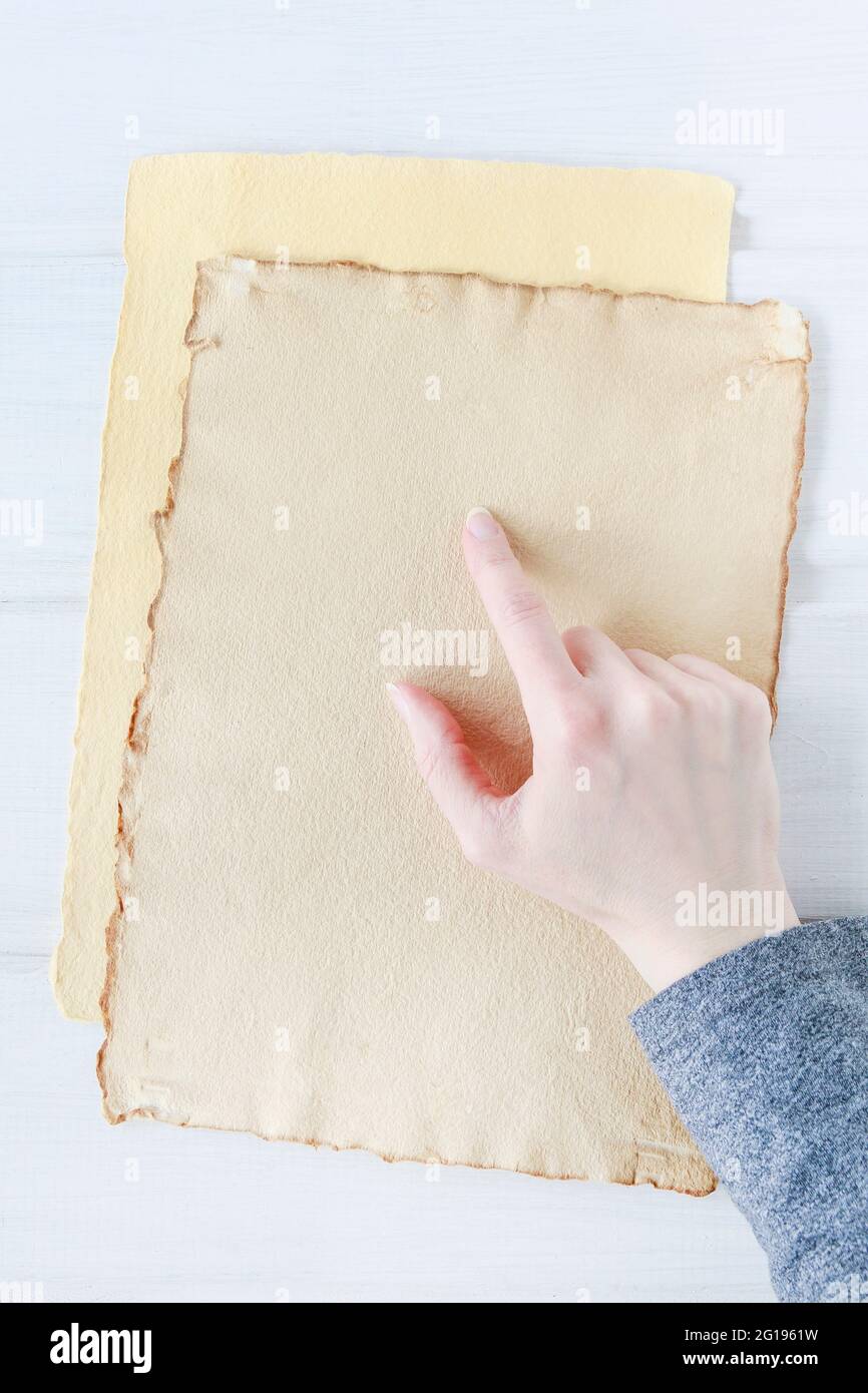 Woman points with her finger something on blank sheet of paper. Cover ...