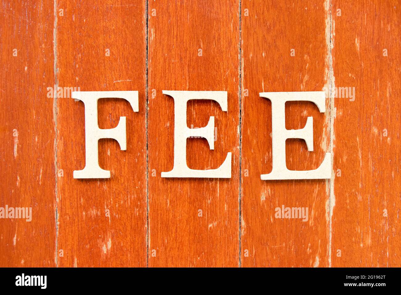 Alphabet letter in word fee on old red color wood plate background ...