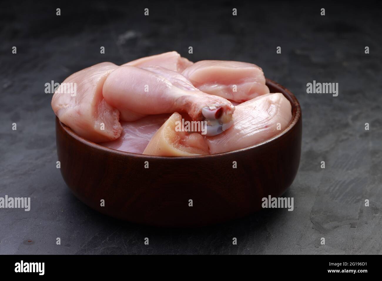 Raw chicken tender curry cut without skin arranged on wooden bowl on ...
