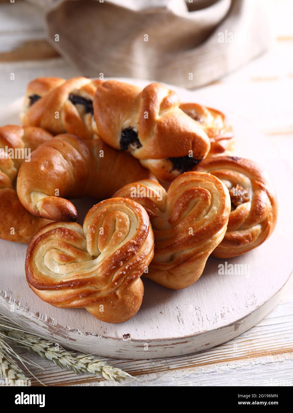 sweet buns with milk for breakfast Stock Photo - Alamy