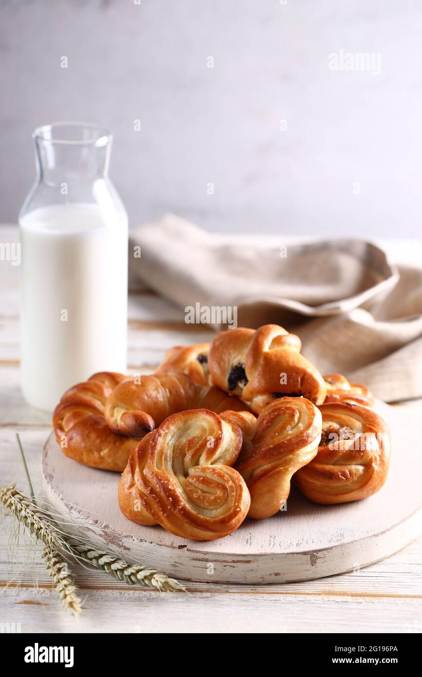 sweet buns with milk for breakfast Stock Photo - Alamy