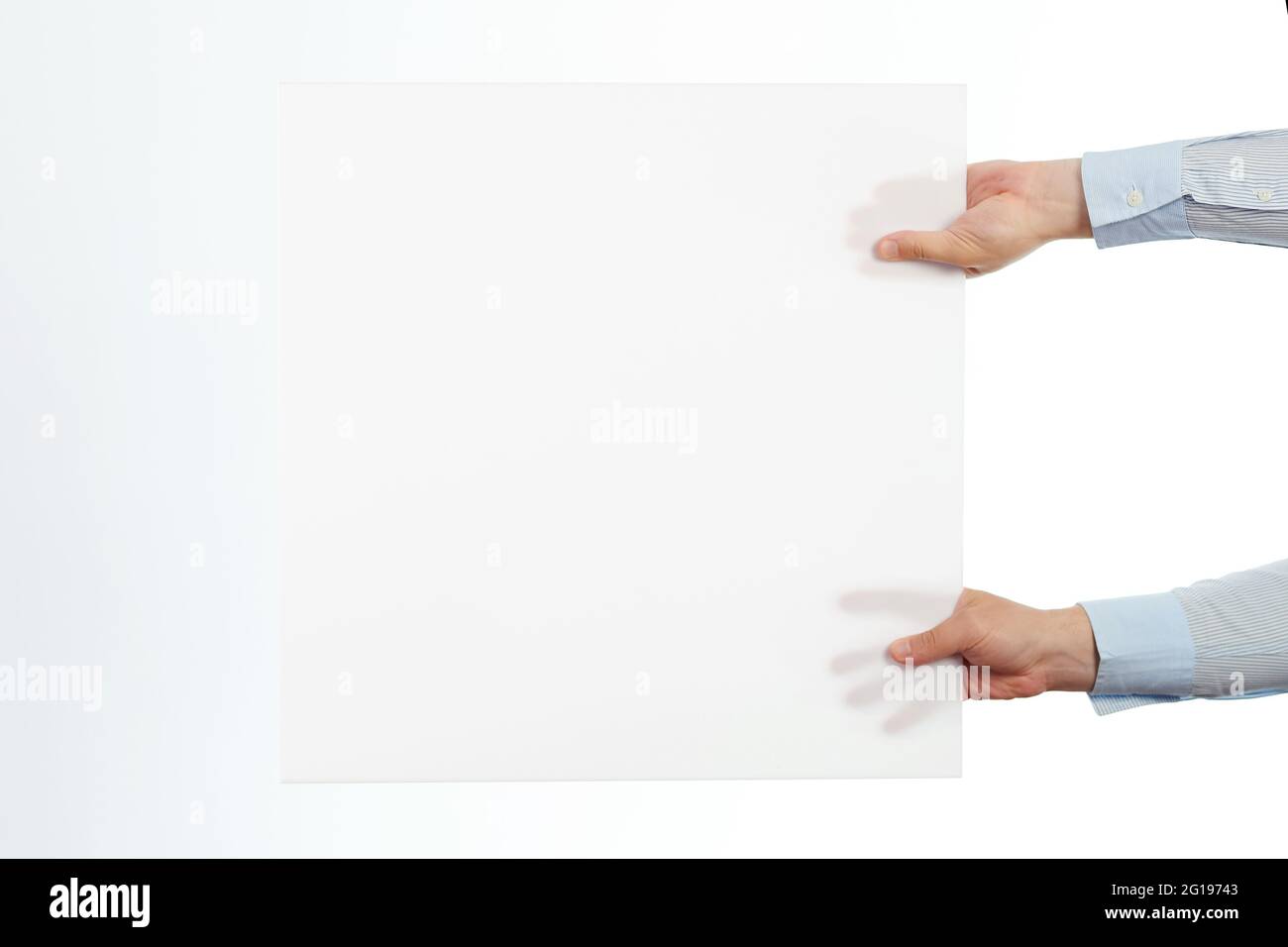 Hands hold white square poster isolated on white studio background ...