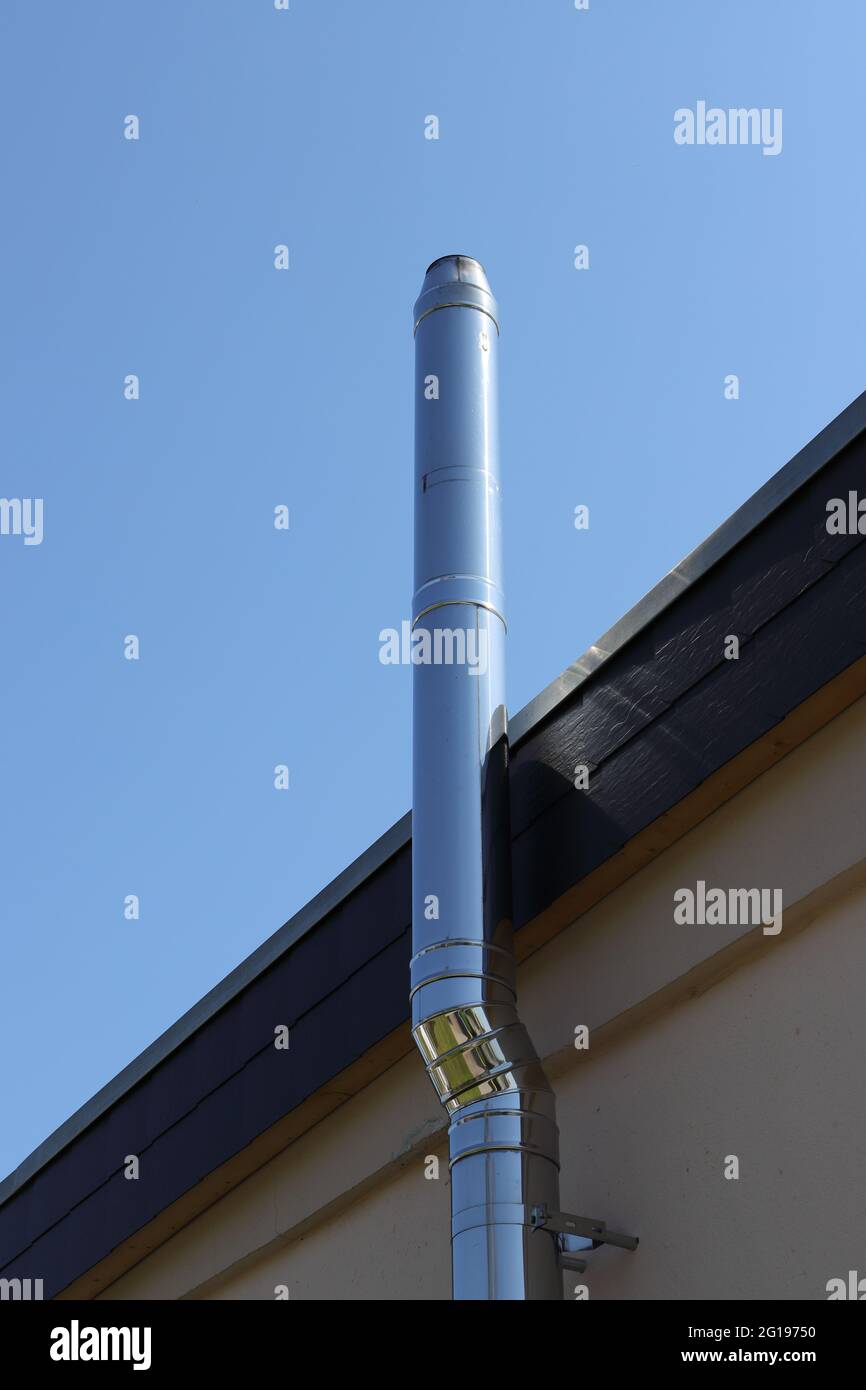 new stainless steel chimney on a house Stock Photo - Alamy
