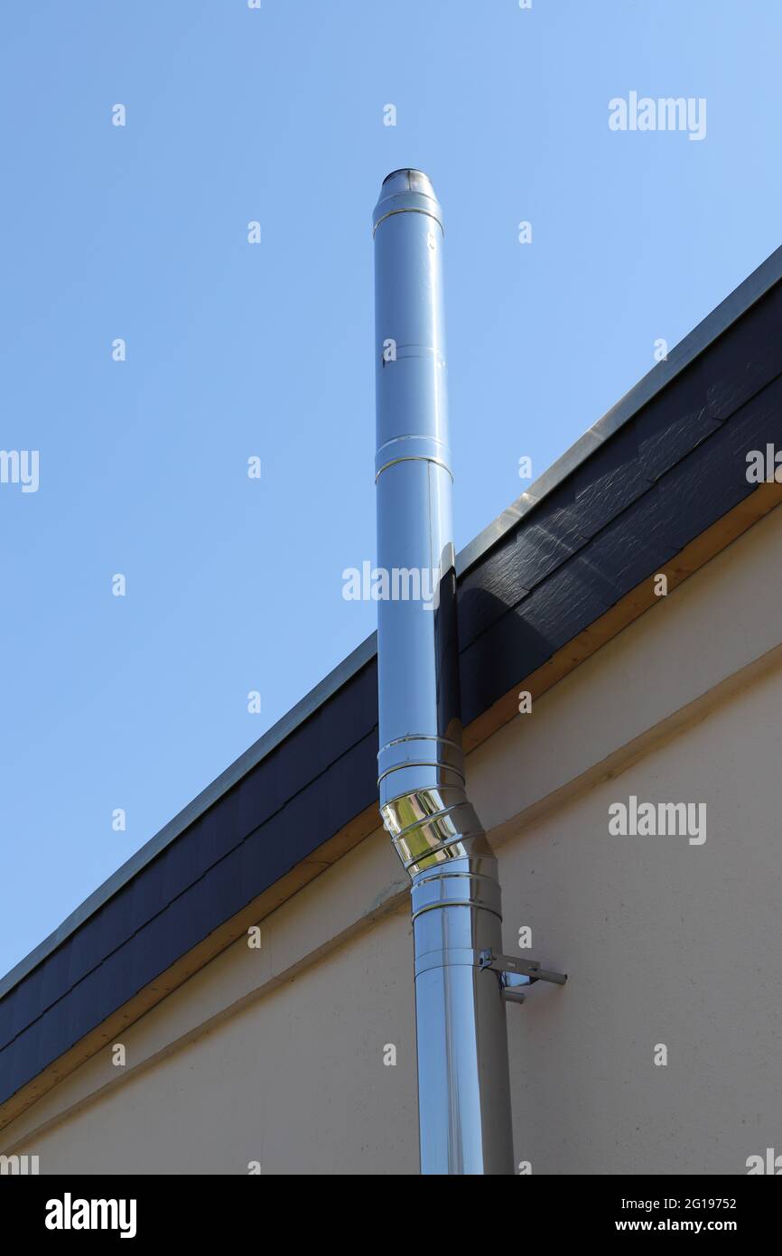 new stainless steel chimney on a house Stock Photo - Alamy