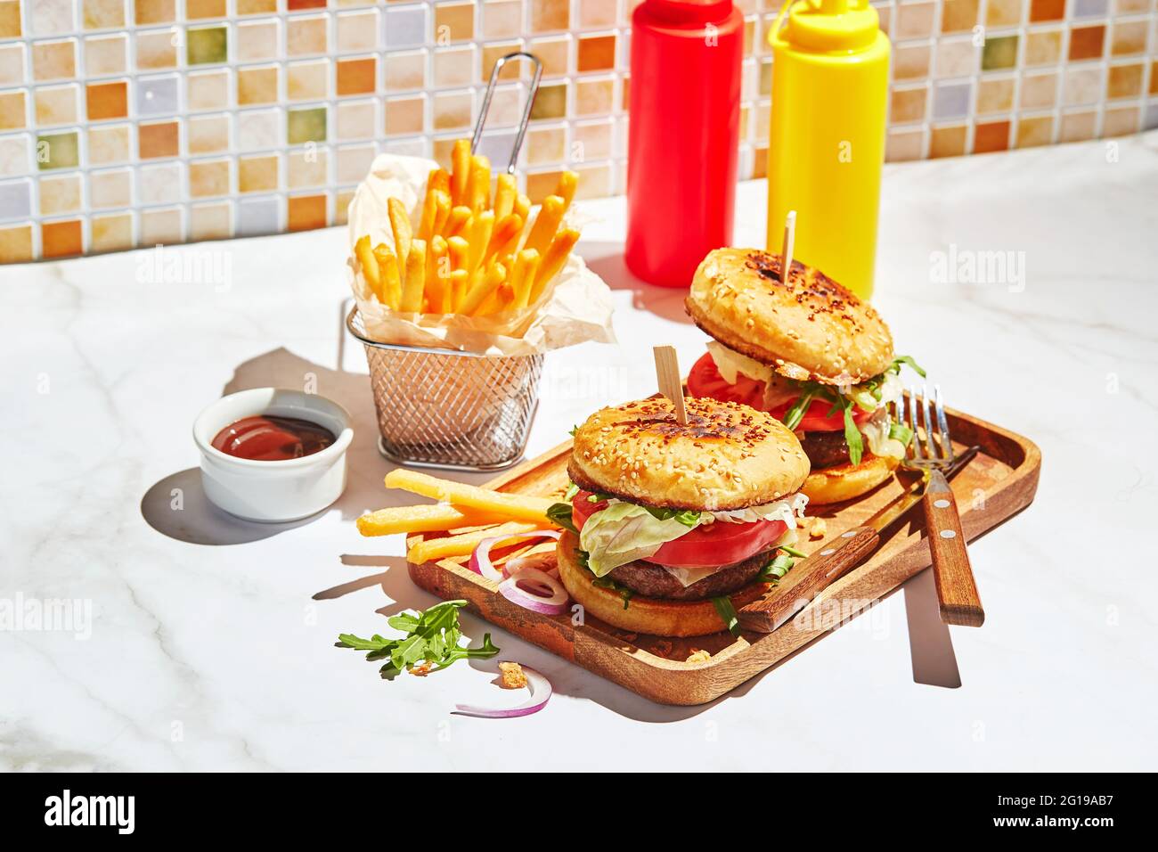 Delicious homemade burgers on wooden tray in bright sunlight. Burgers ...