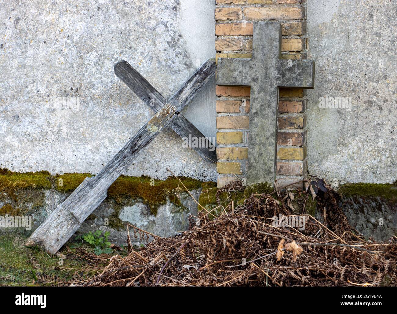 An old crosses leaning against a wall in a cemetery Stock Photo - Alamy