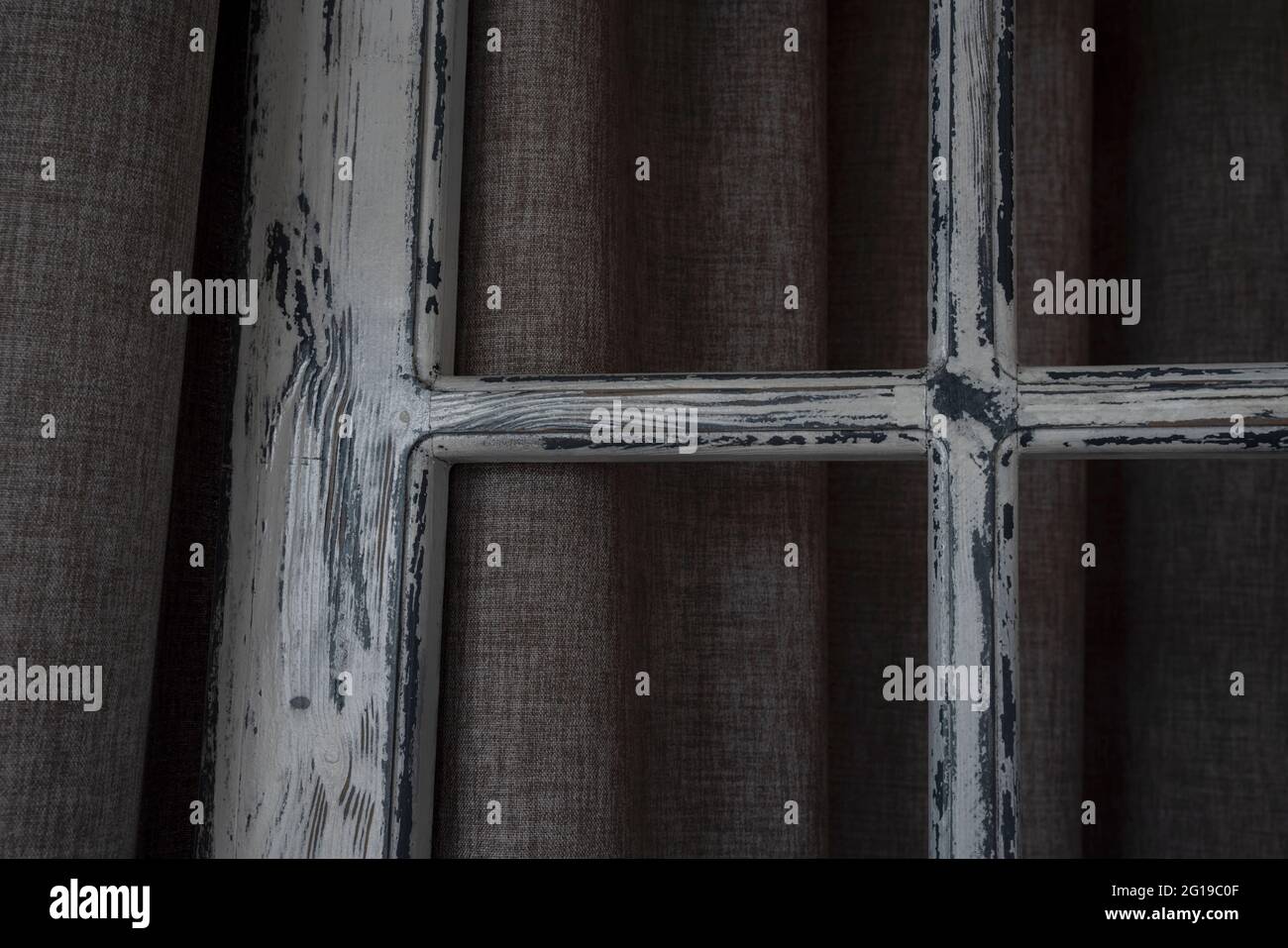 Vintage wooden window with fading white paint on a dark background ...