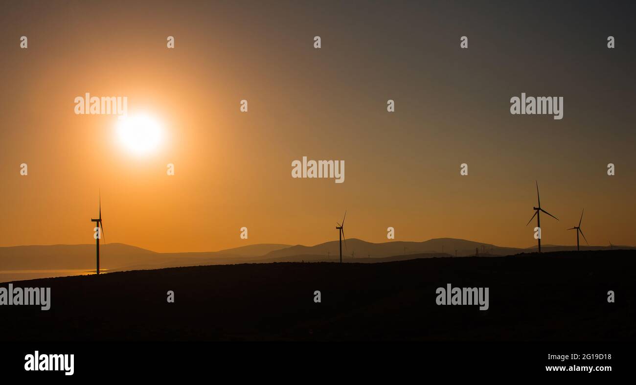View of wind turbine, Aegean sea and landscpae at sunset captured in ...
