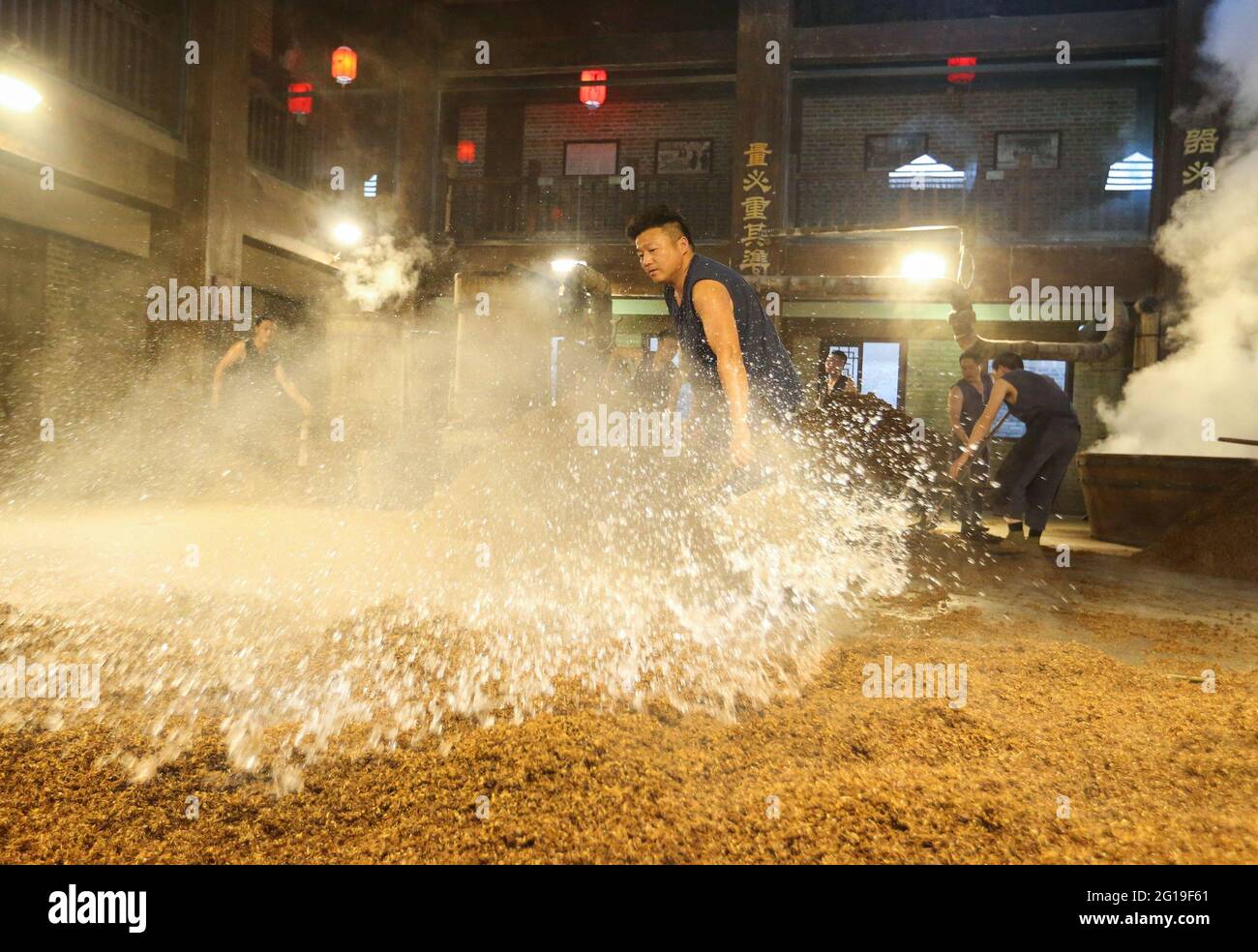 SUIQIAN, CHINA - JUNE 5, 2021 - Brewers add water to fermented grains ...