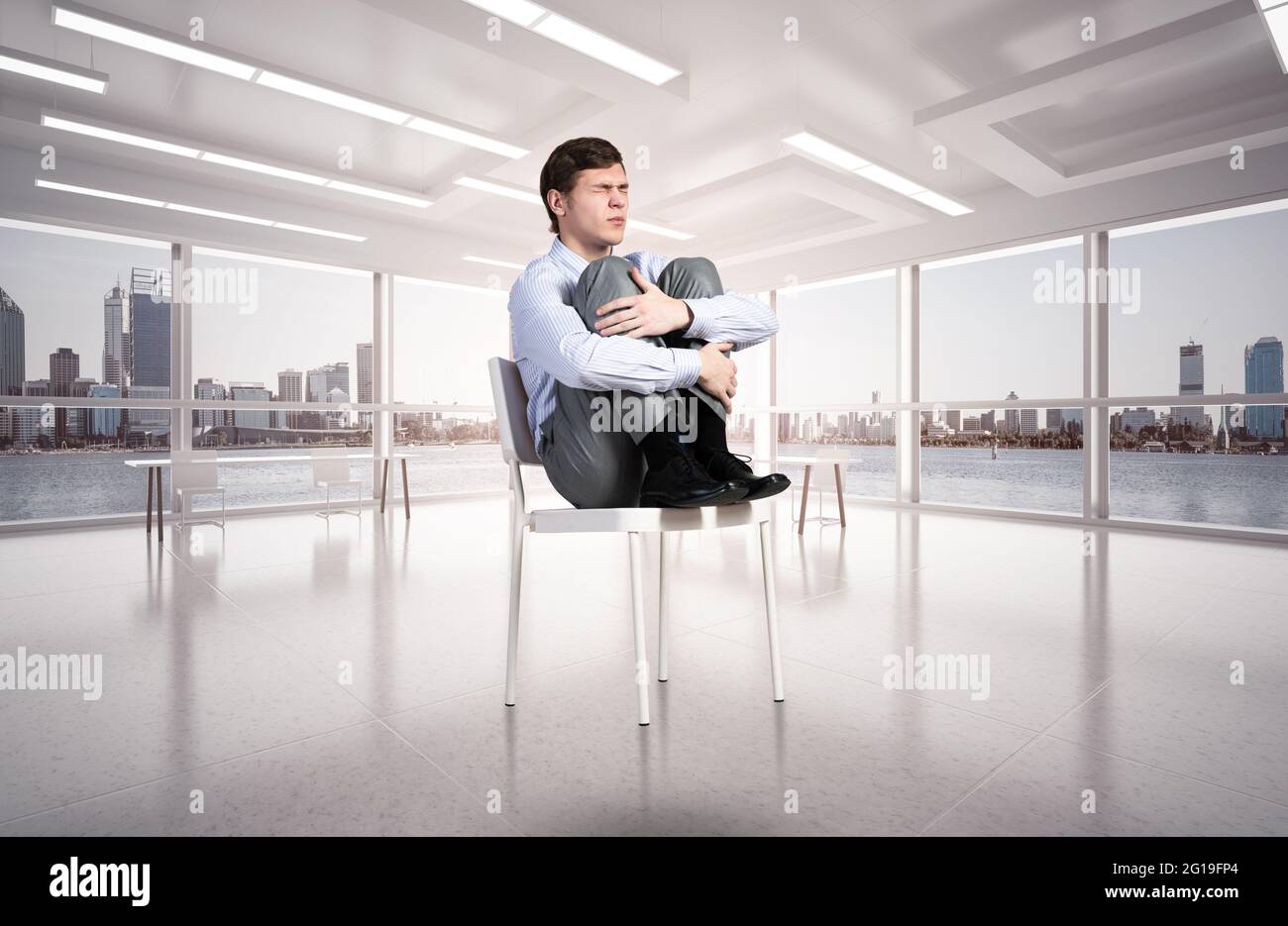 scared businessman on a chair in office Stock Photo - Alamy