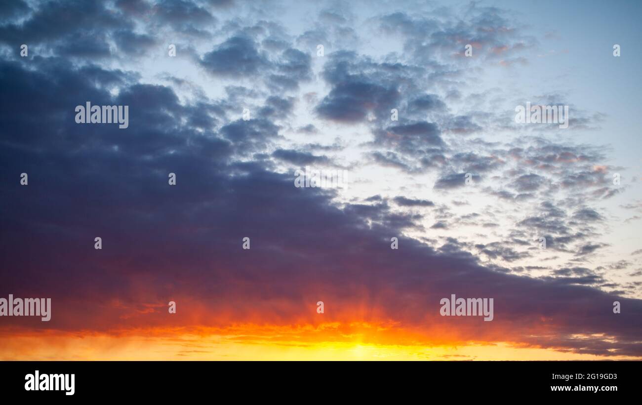 Colorful sunset or sunrise in the sky. The sky and clouds are painted ...