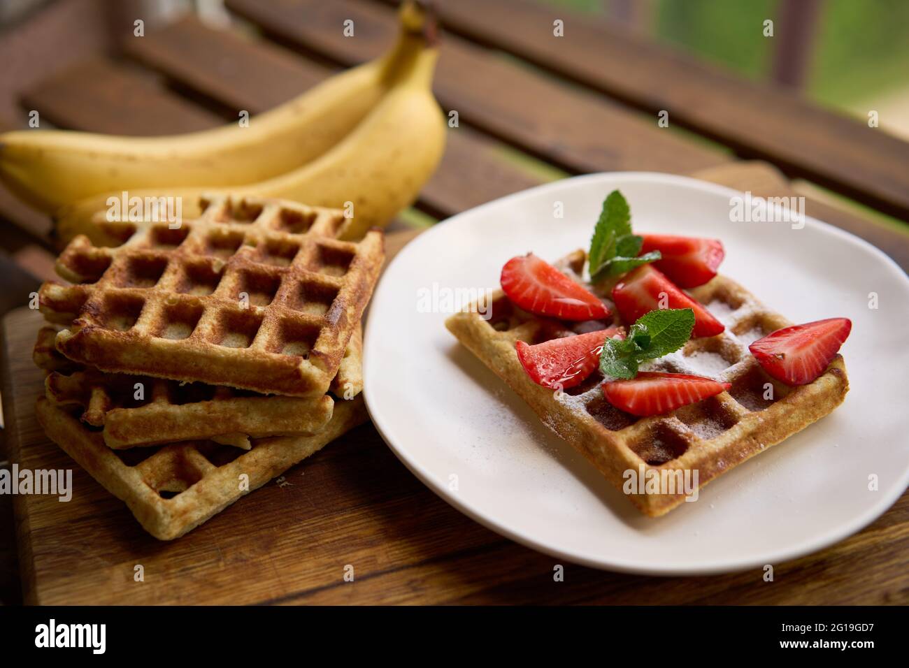 Closeup view of breakfast belgium waffles with strawberry and banana ...