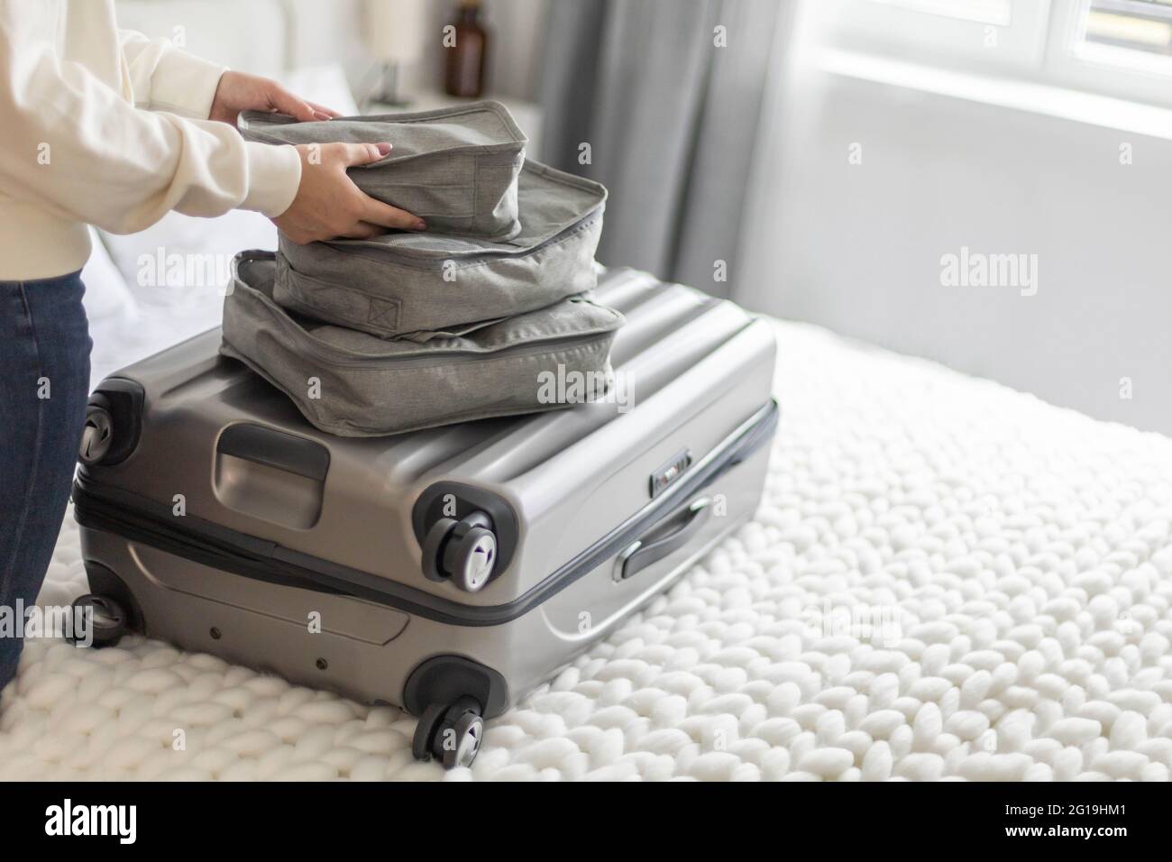 female packing things in briefcase use konmari method getting ready to ...